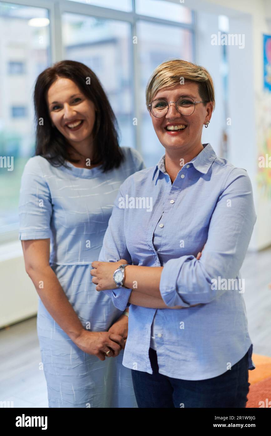 Portrait of a two teacher in a preschool institution, in the background ...