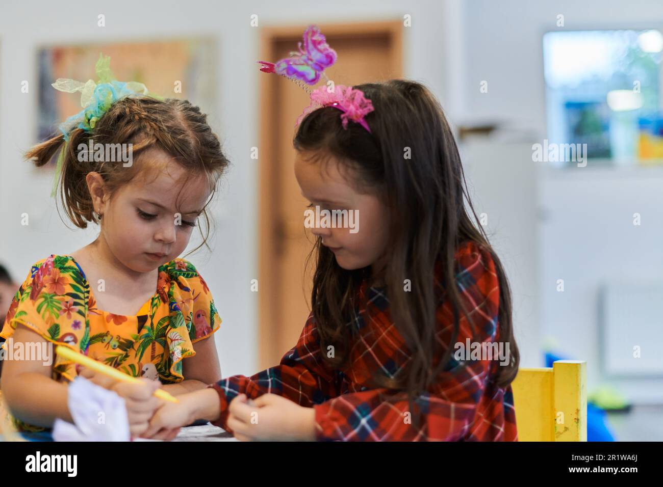 Creative kids sitting in a preschool institution, draw and have fun ...