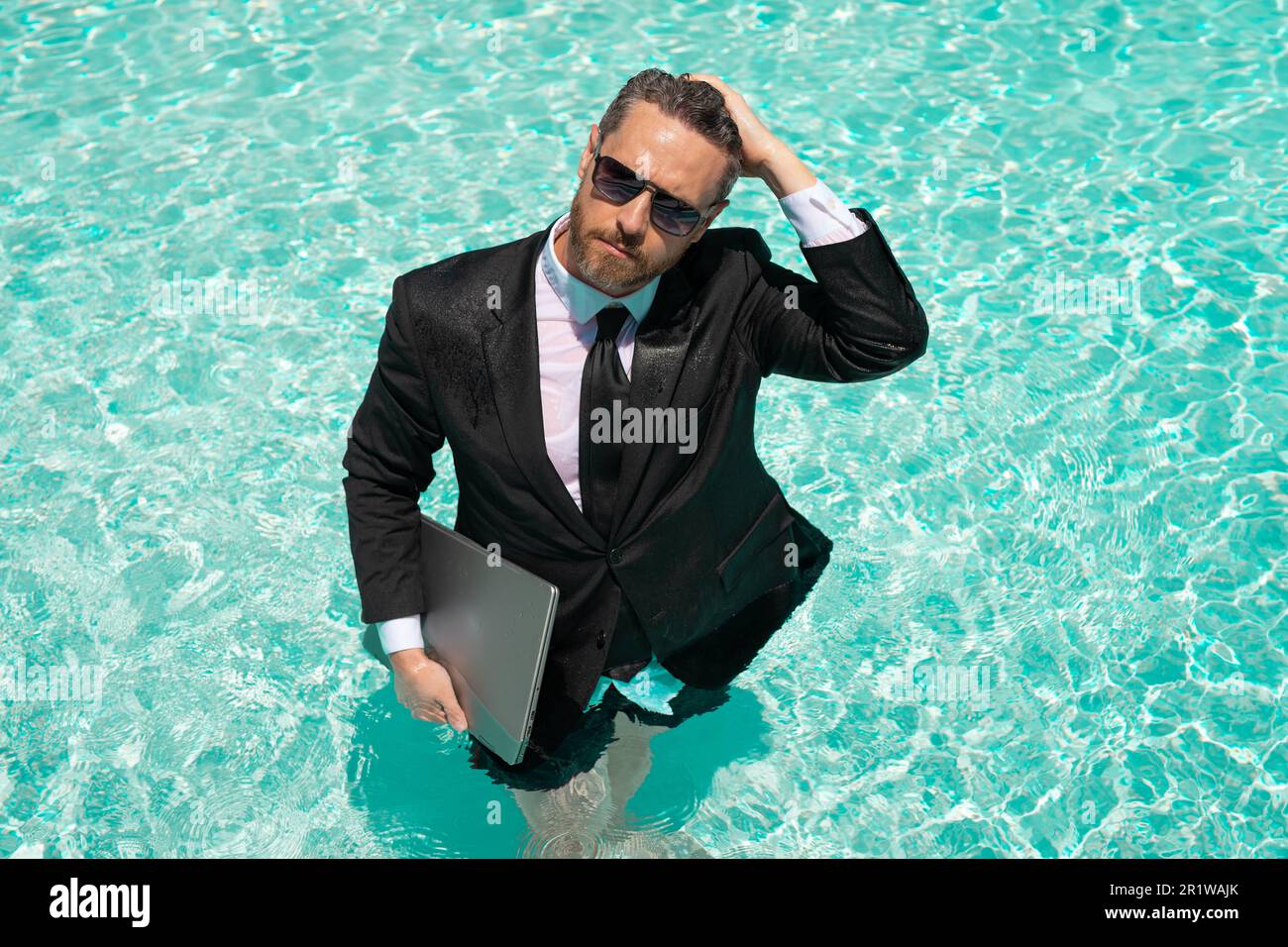 image of business man working remote in summer pool with laptop Stock ...