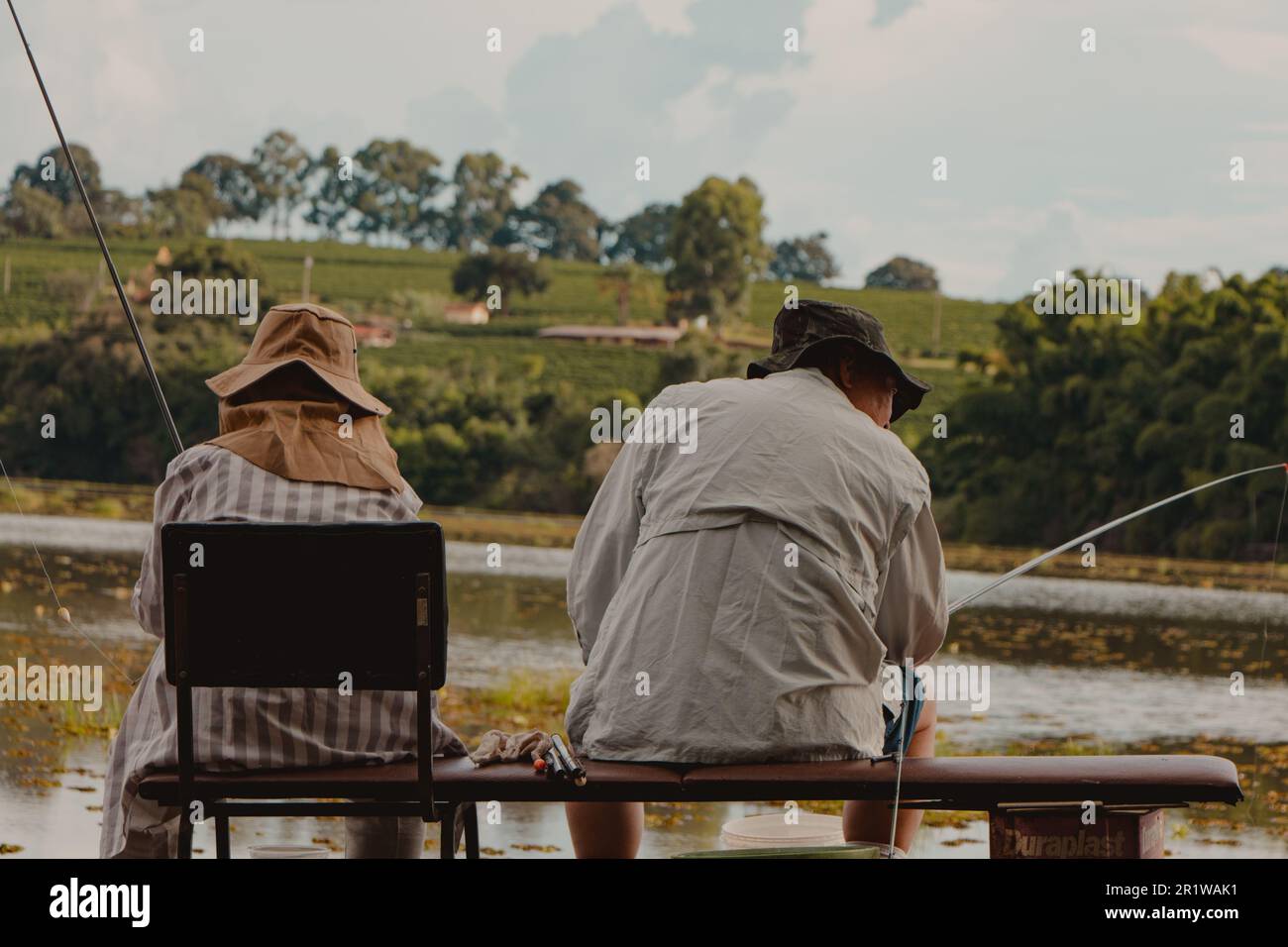 couple sitting fishing Stock Photo - Alamy