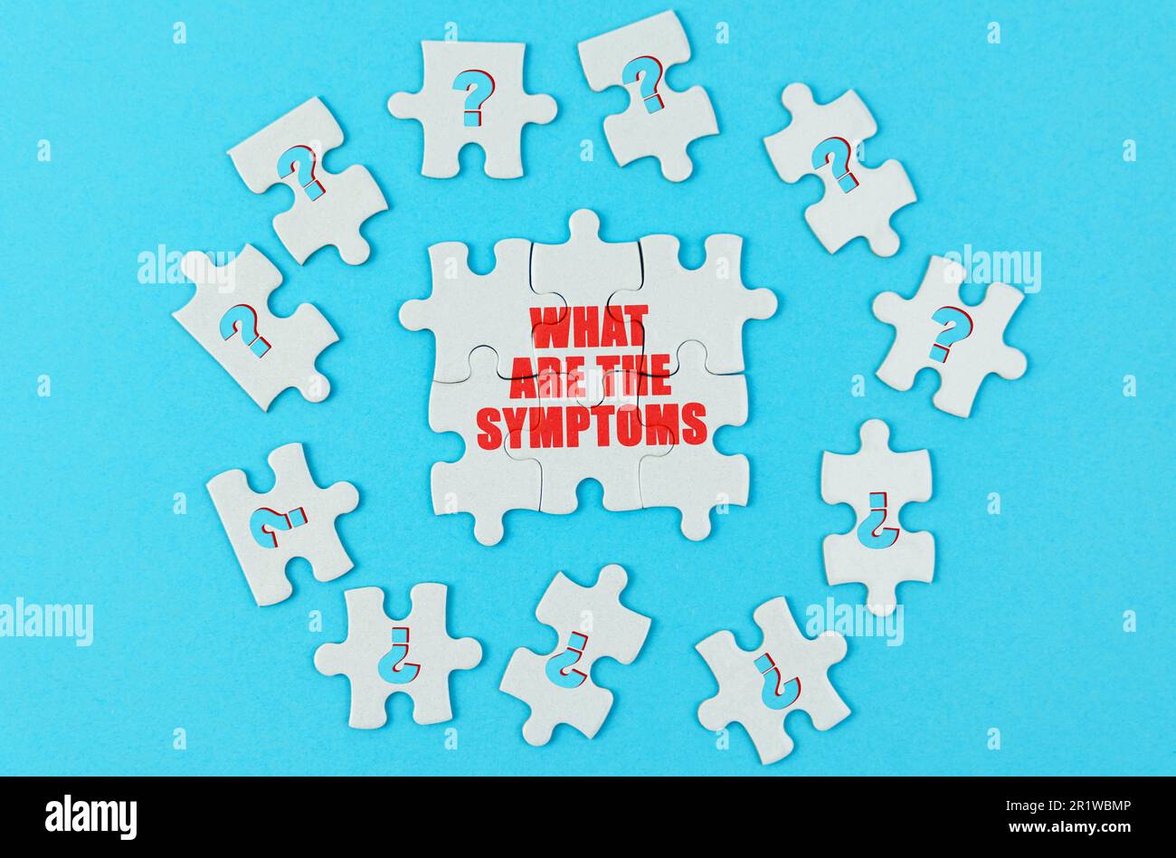Medical concept. On a blue surface are puzzles with a question mark, in ...