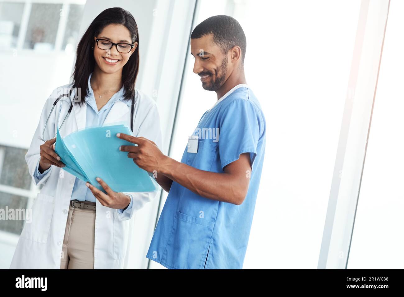 Sharing medical theories. two young doctors discussing the contents of ...