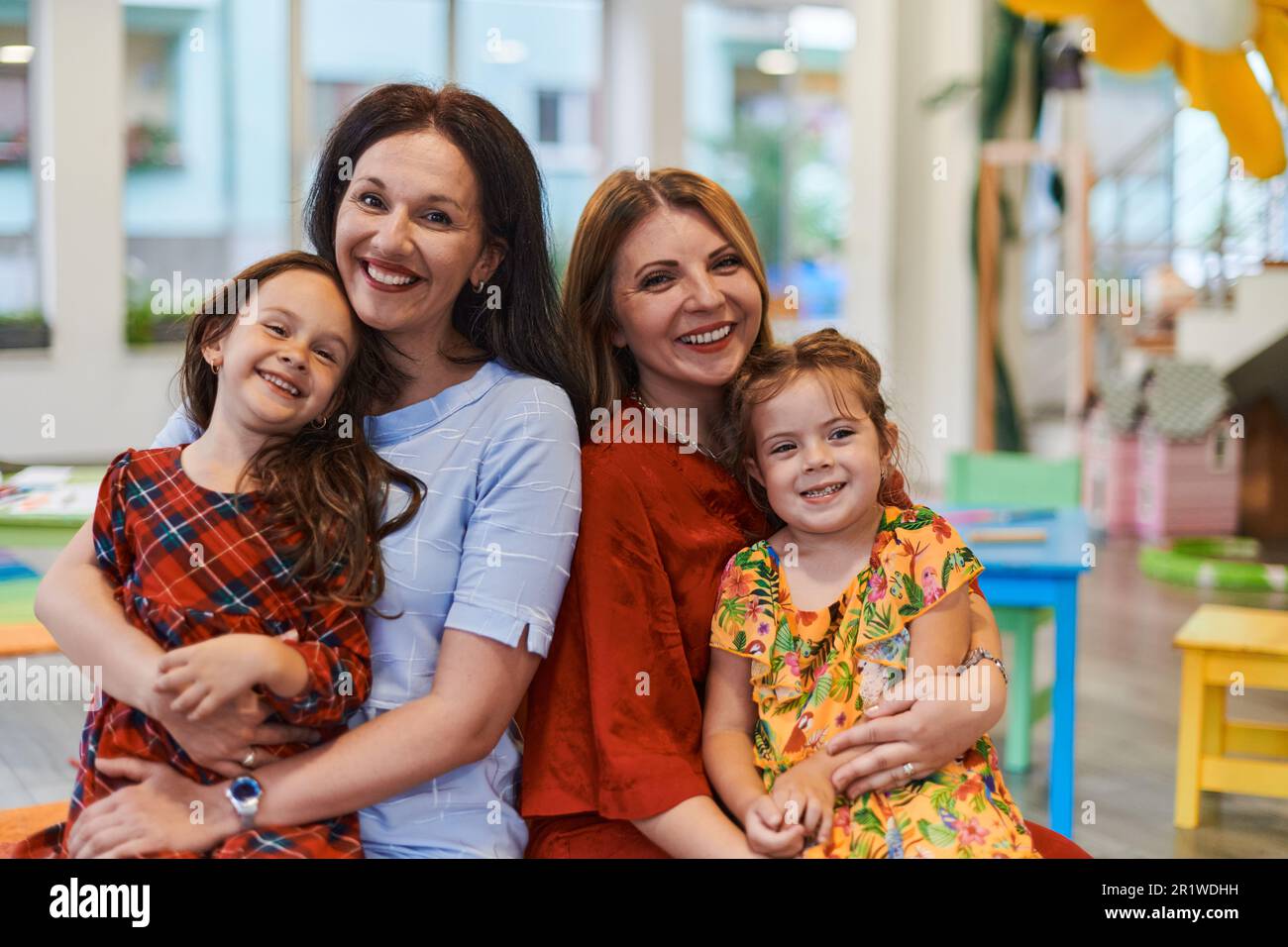 A child hugging a teacher in a modern kindergarten Stock Photo - Alamy