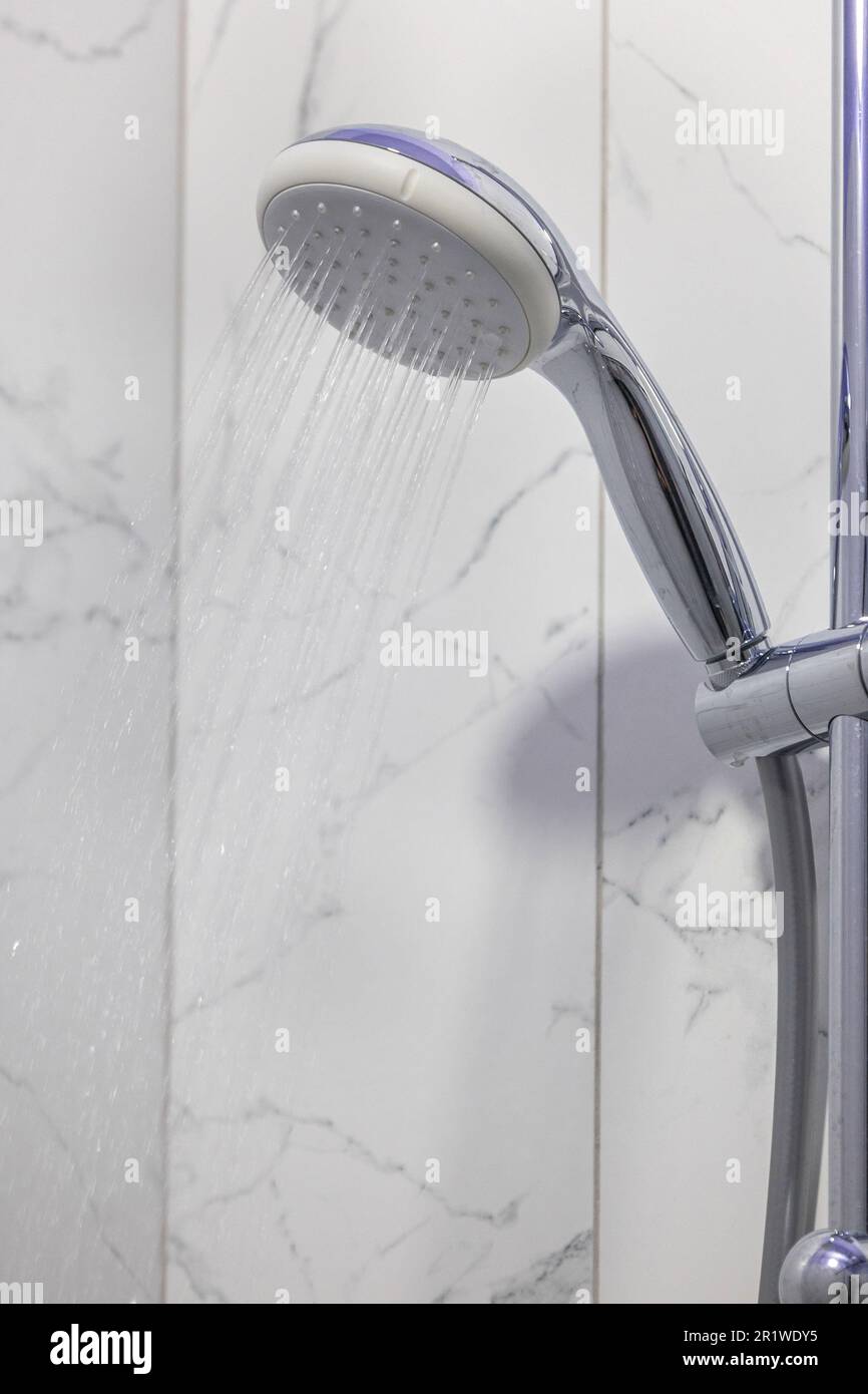 Stream of water splashing out of shower in modern bathroom. Jets of ...