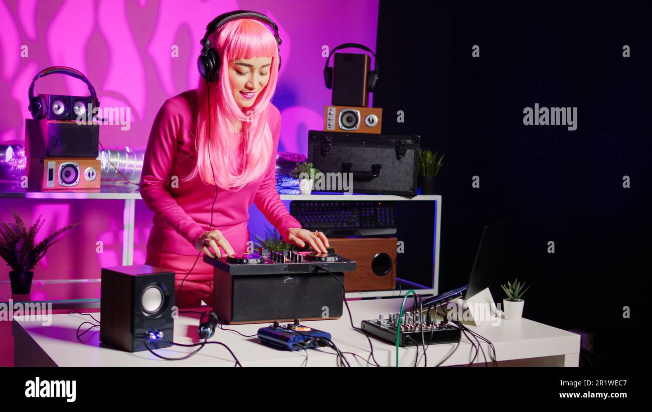 Smiling musician working as dj playing song at mixer Stock Photo - Alamy