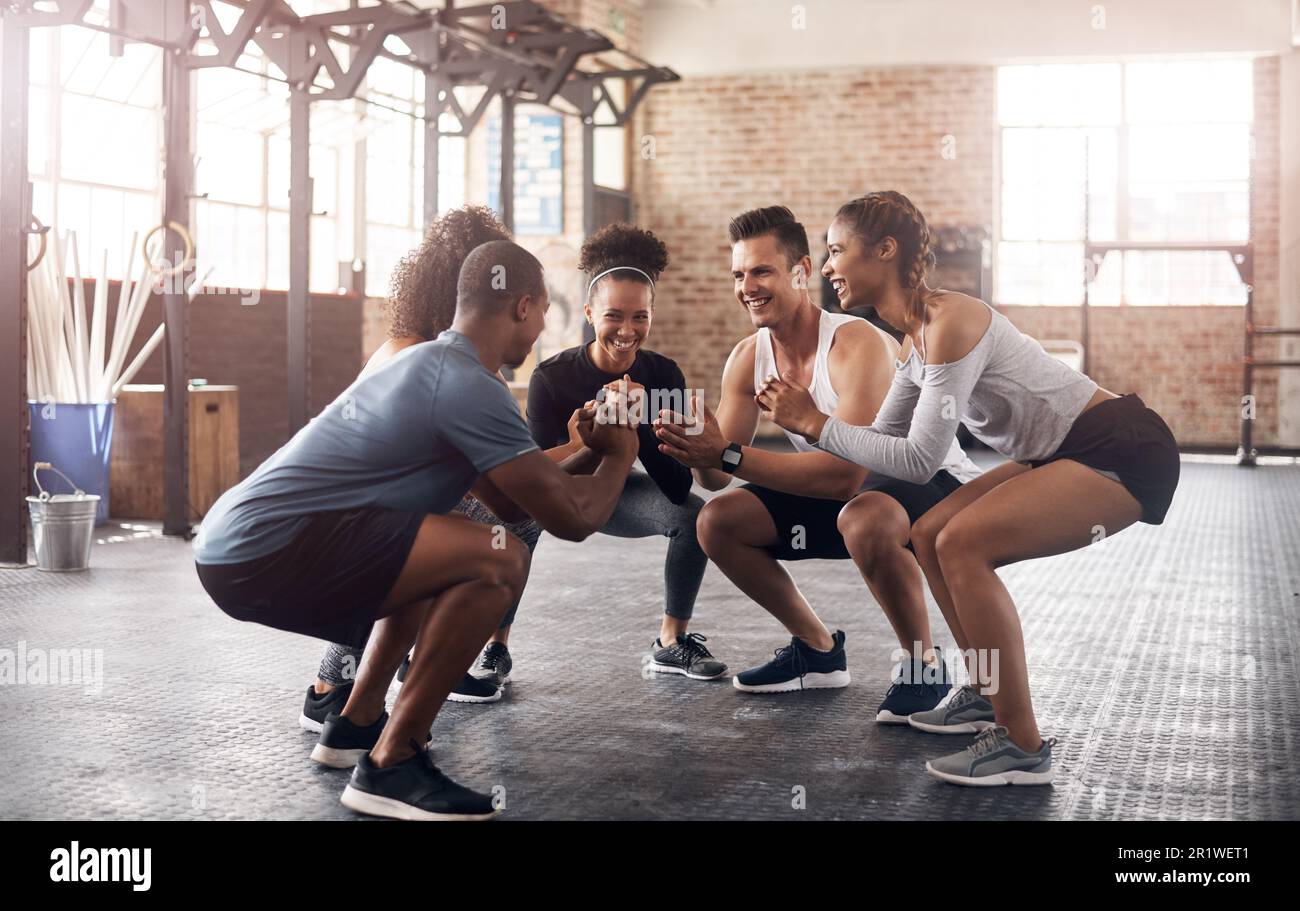 Get ready for strong glutes. a group of young people doing squats ...