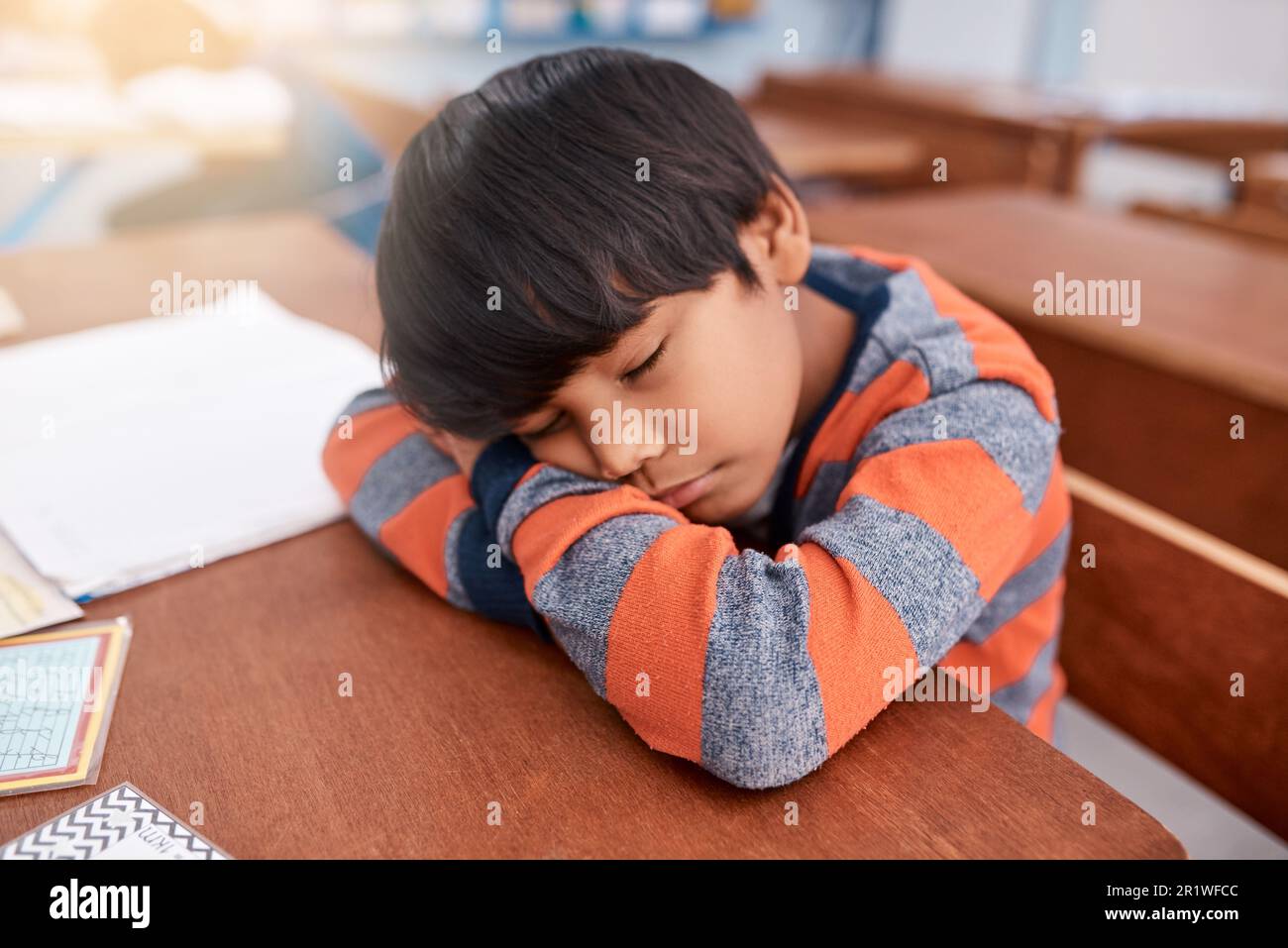 Just five more minutes. a tired elementary school child sleeping on his ...