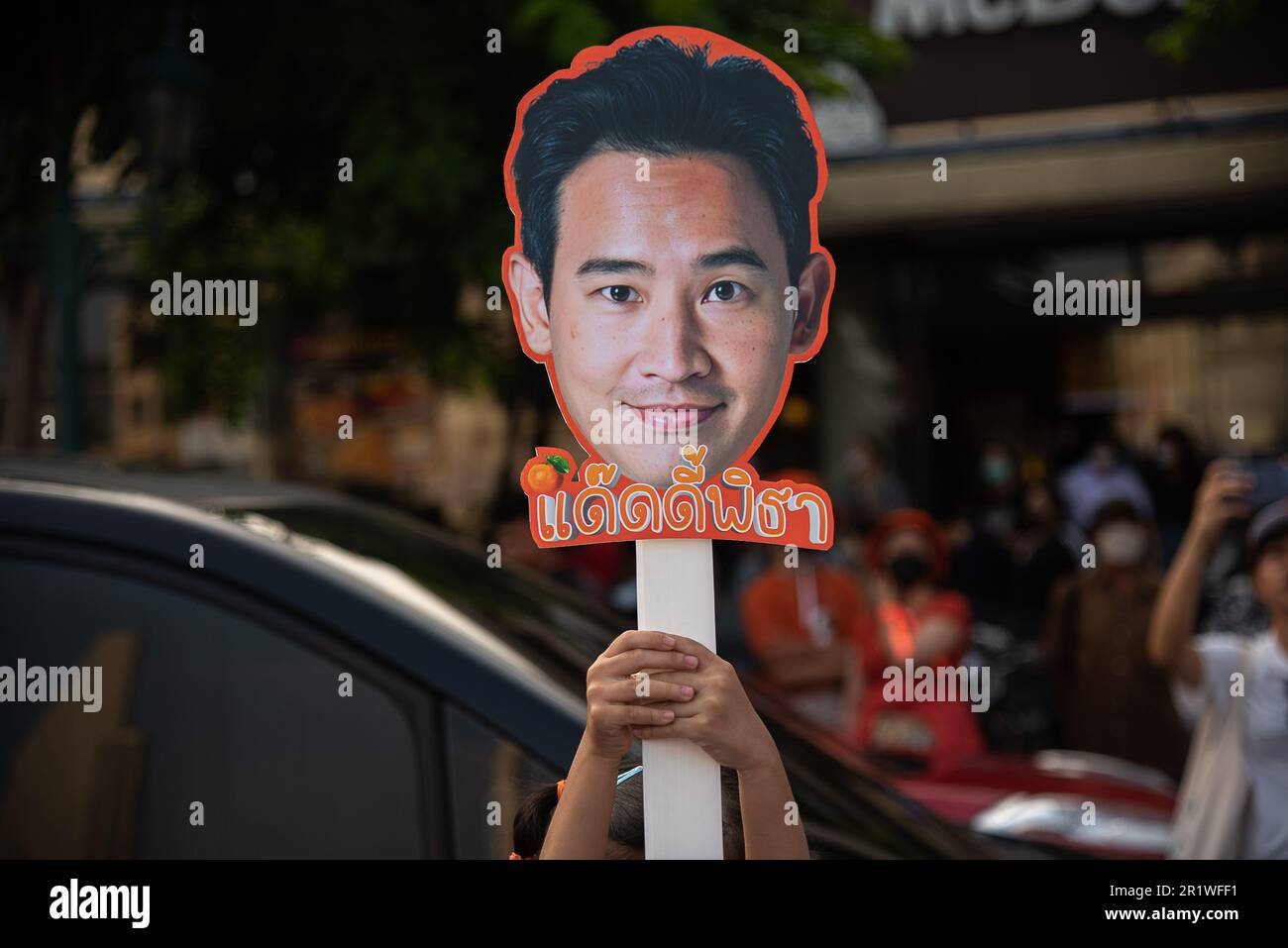 Bangkok, Thailand. 15th May, 2023. A supporter holds a fan of Pita Limjaroenrat, prime minister ...