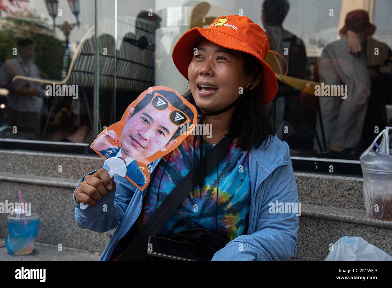 Bangkok, Thailand. 15th May, 2023. A supporter holds a fan of Pita Limjaroenrat, prime minister ...