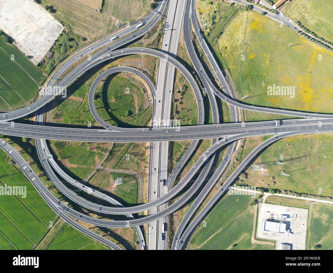 Aerial view of a four-lane highway intersection with a car driving ...