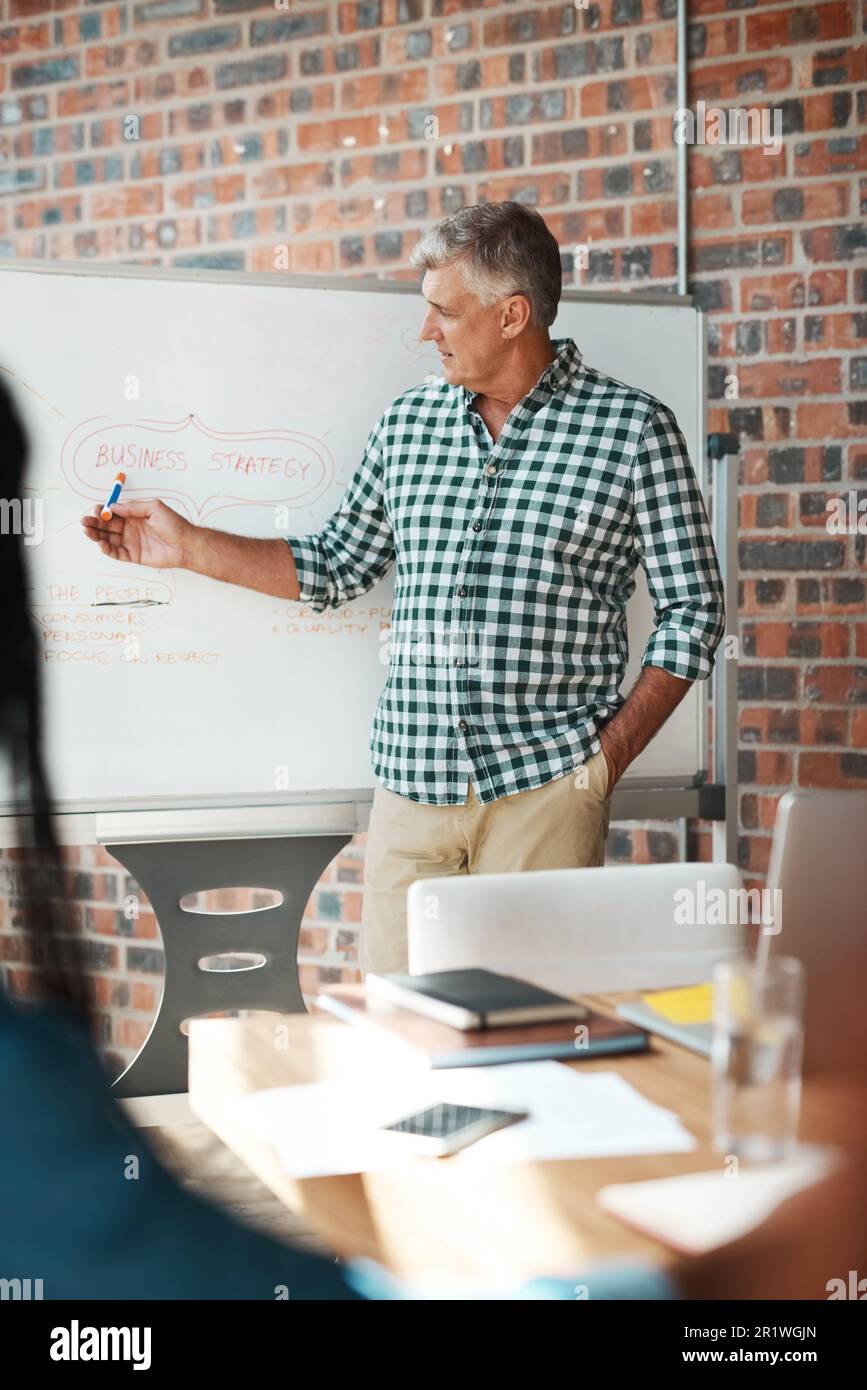 Presenting the grand master plan. a businessman giving a presentation ...