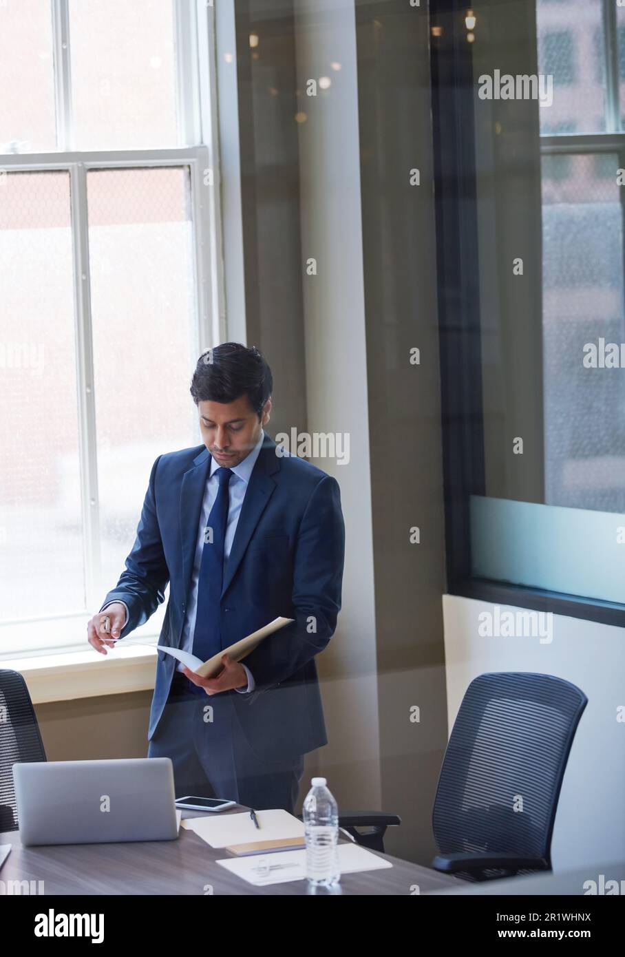 Taking a look back at the paper trail. a businessman looking at ...