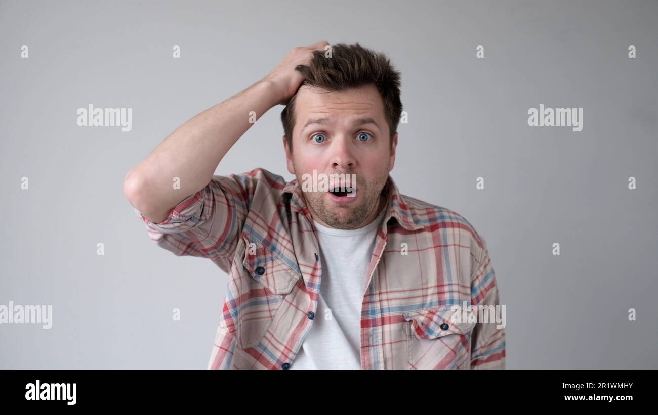 European young person, in bewilderment, grabs their head and asks how ...