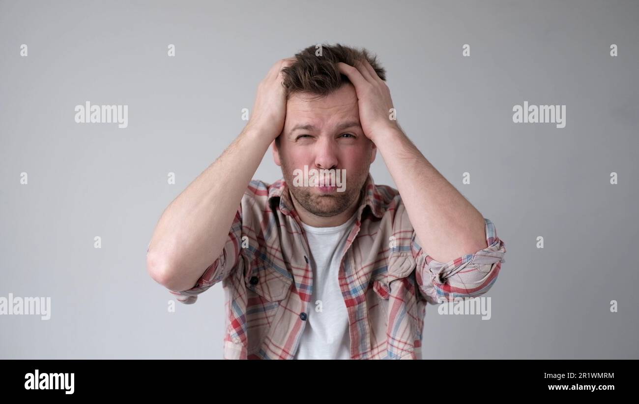 European young person, in bewilderment, grabs their head and asks how ...