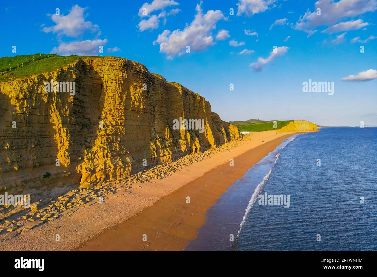 West Bay, Dorset, UK. 15th May 2023. UK Weather. View from the air of the iconic sand stone ...