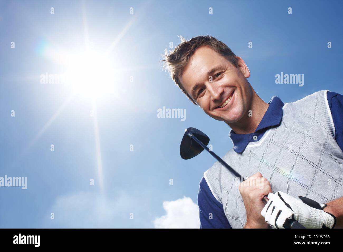 Lets get golfing. Smiling mature man holding his golf club while ...