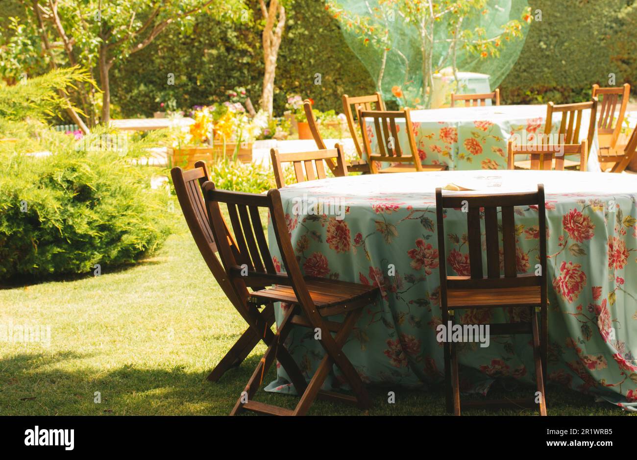 Beautifully set tables with floral tablecloths. Private backyard party ...
