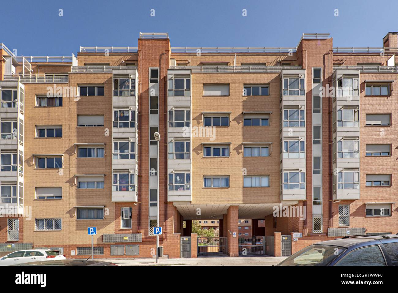 Front facade of urban residential buildings with access to garages and ...