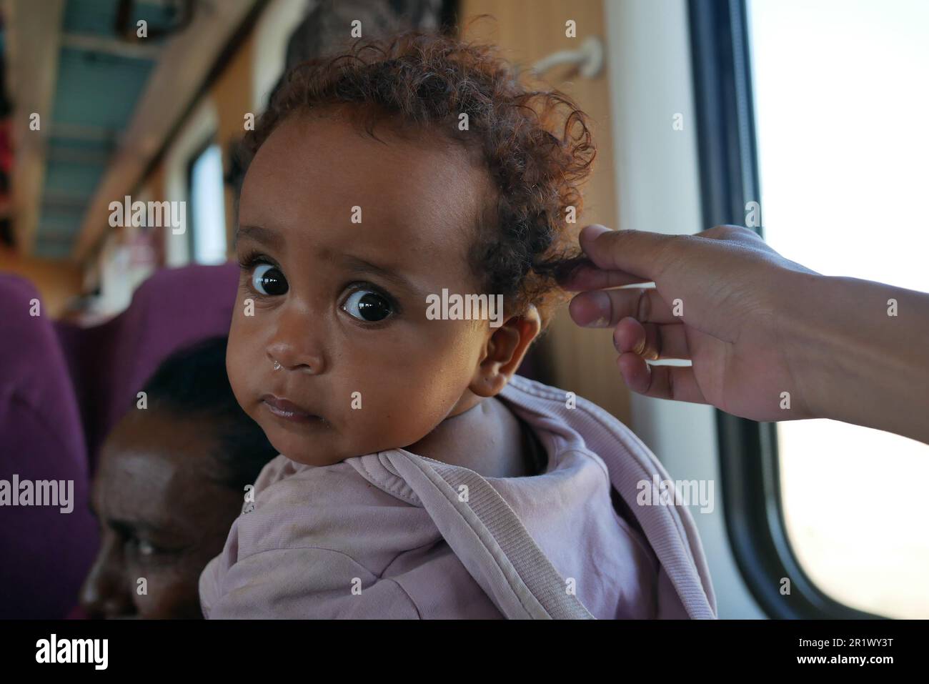 Dire Dawa, Ethiopia â€“ 11.06.2022: baby ethiopian girl wide-eyed as ...