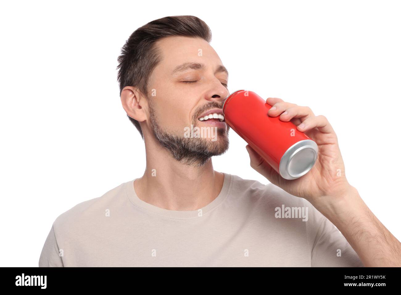 Happy man drinking from tin can on white background Stock Photo - Alamy