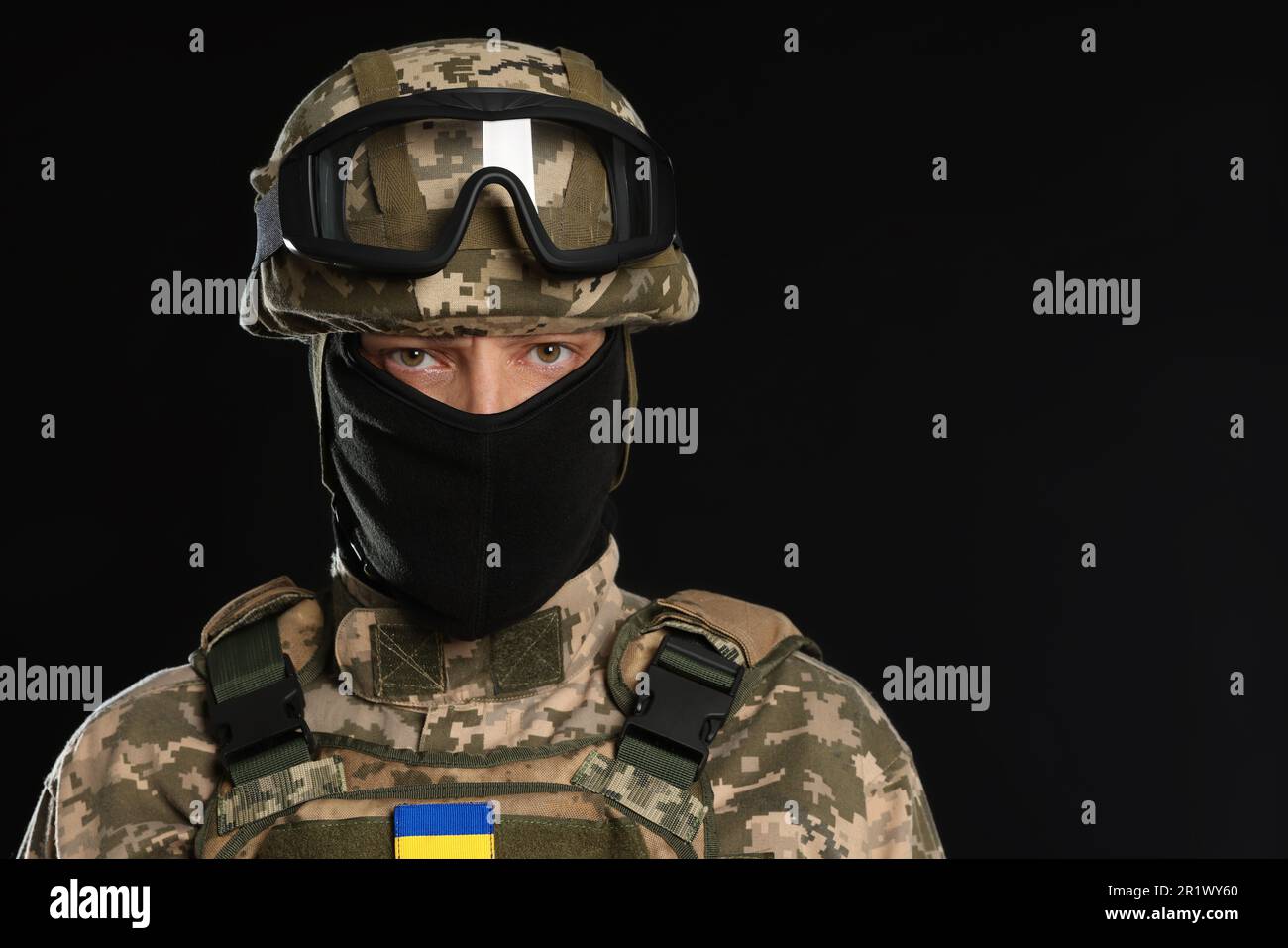 Soldier in Ukrainian military uniform, tactical goggles and balaclava ...