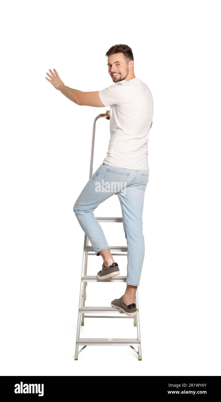Young man climbing up metal ladder on white background Stock Photo - Alamy