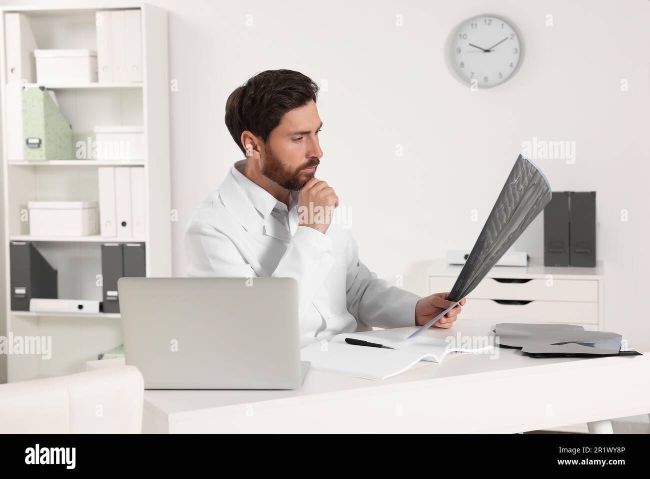 Doctor examining neck MRI scan in hospital Stock Photo - Alamy