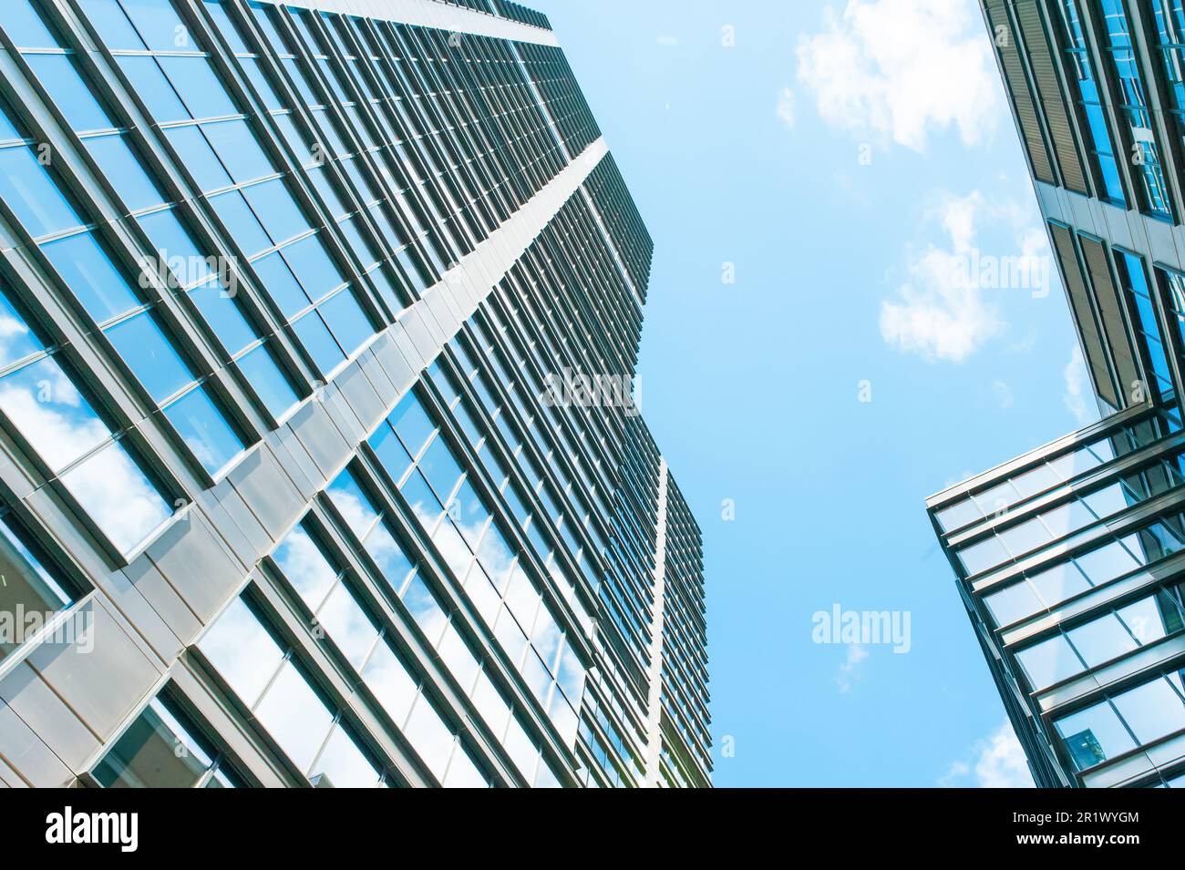 Stylish buildings with many windows under cloudy sky Stock Photo - Alamy