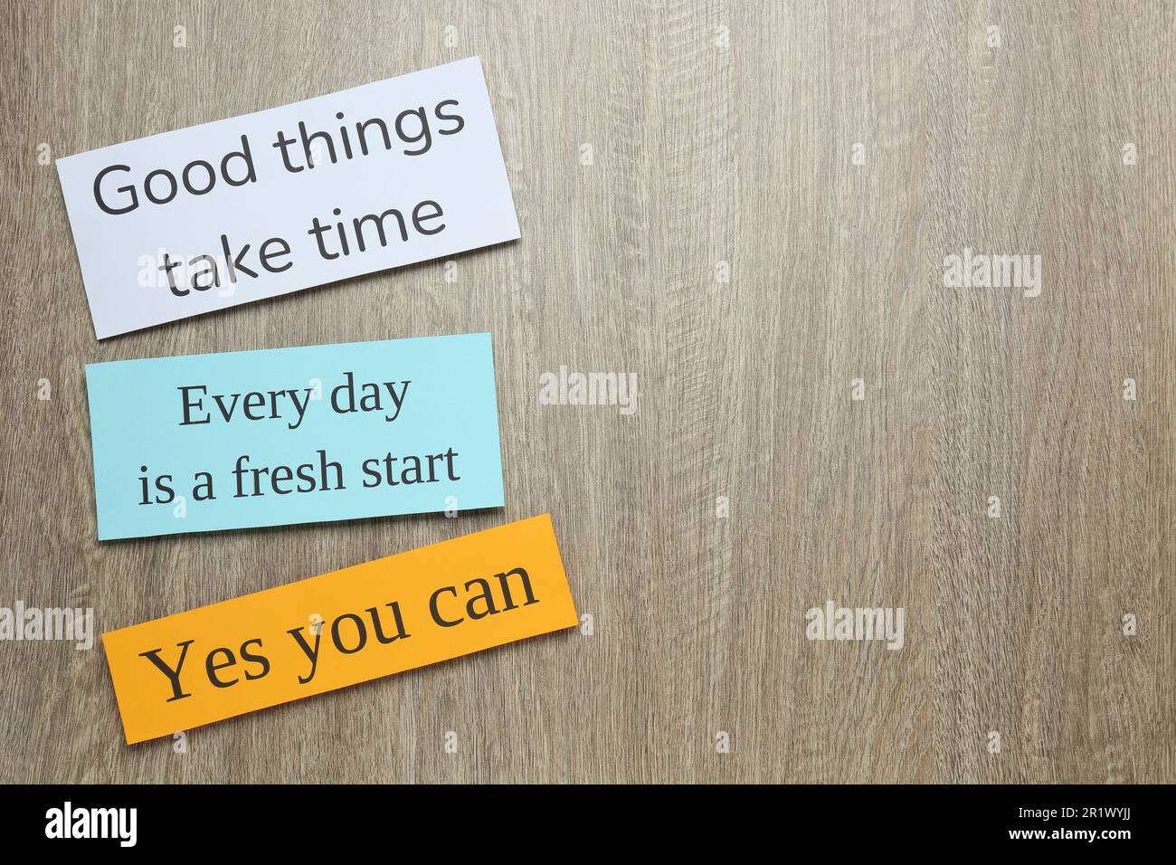 Notes with motivational quotes on wooden background, flat lay. Space ...