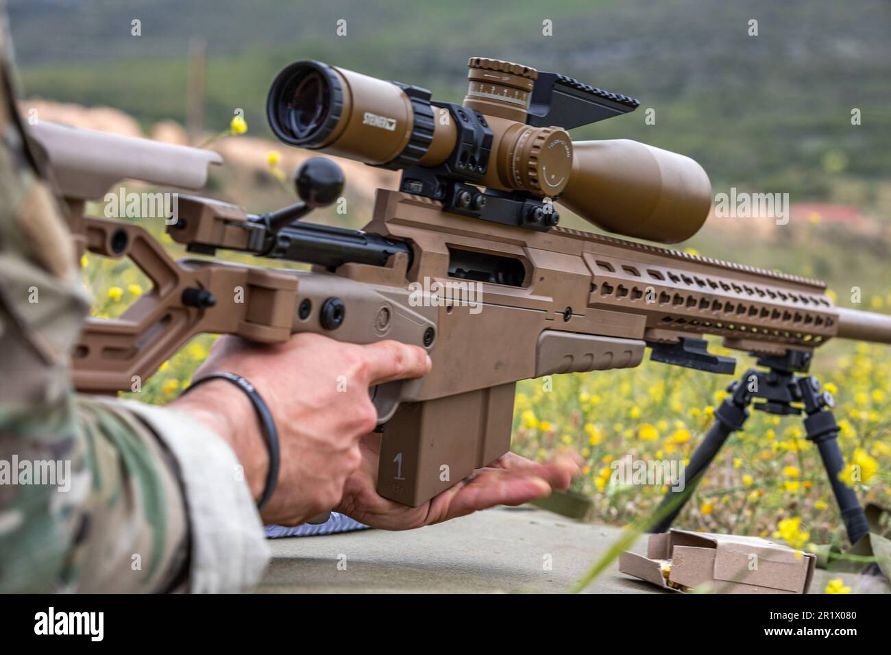 A Hellenic special forces soldier reloads an AXSR advanced sniper rifle ...
