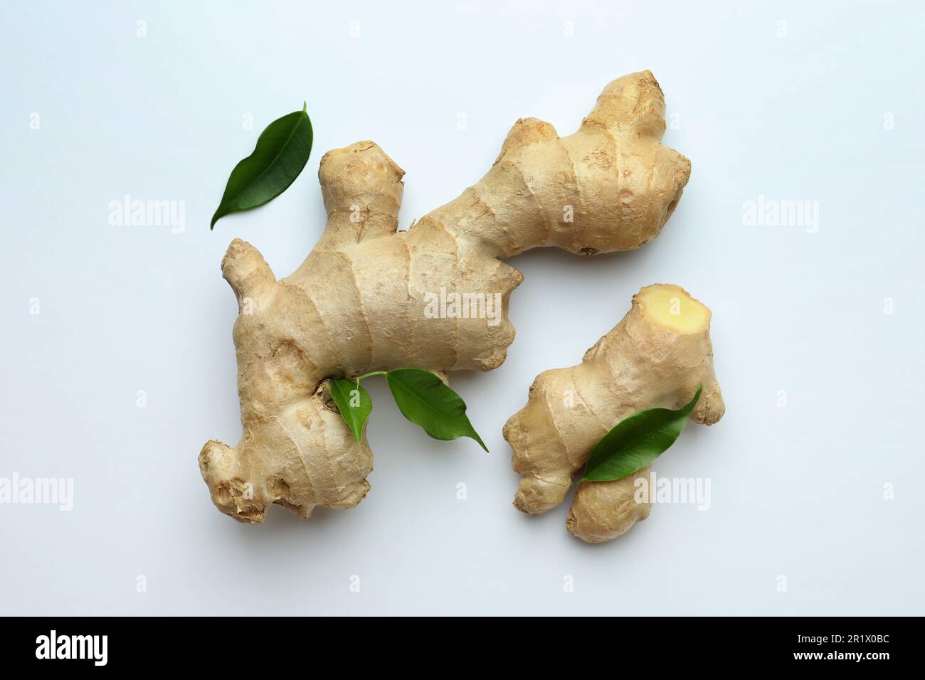 Fresh ginger with green leaves on white background, flat lay Stock ...