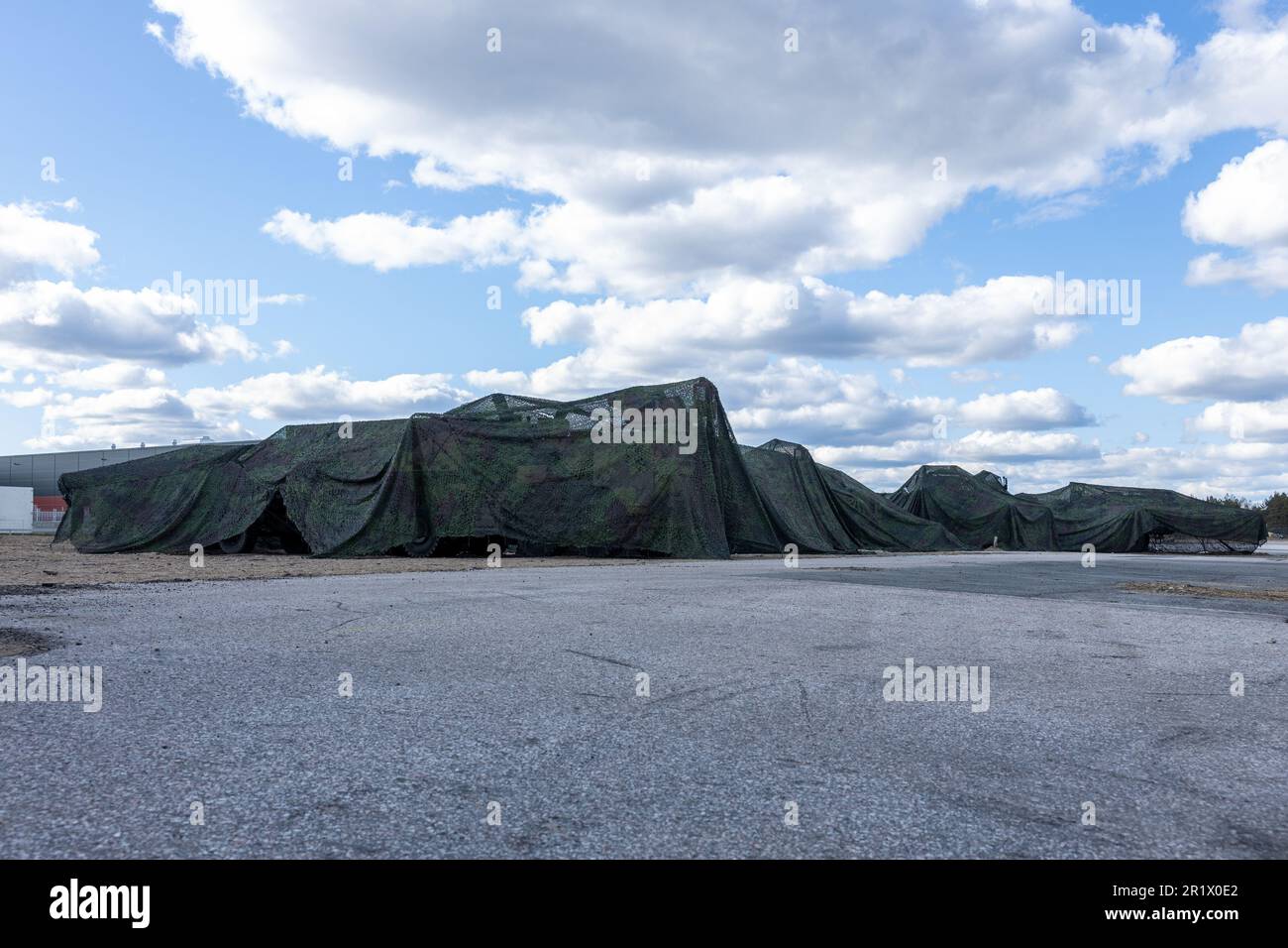 U.S. Marine Corps vehicles are covered in camouflage netting during ...