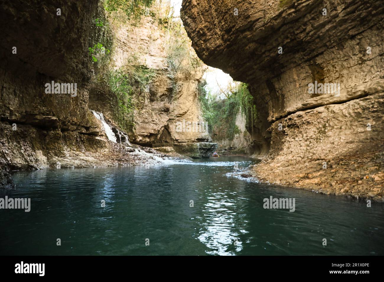 Picturesque view of clean river near cliffs and waterfall outdoors ...