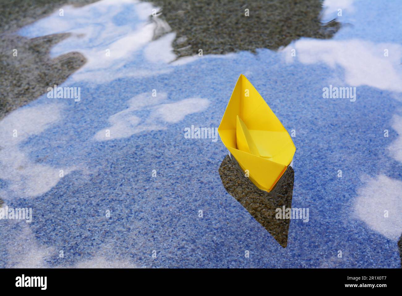 Beautiful yellow paper boat on water outdoors, space for text Stock ...
