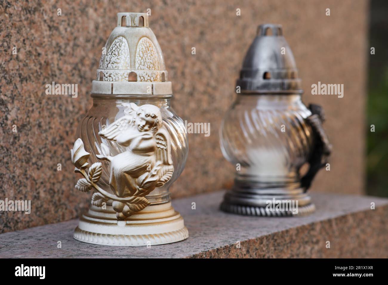 Grave lanterns on granite surface in cemetery Stock Photo - Alamy
