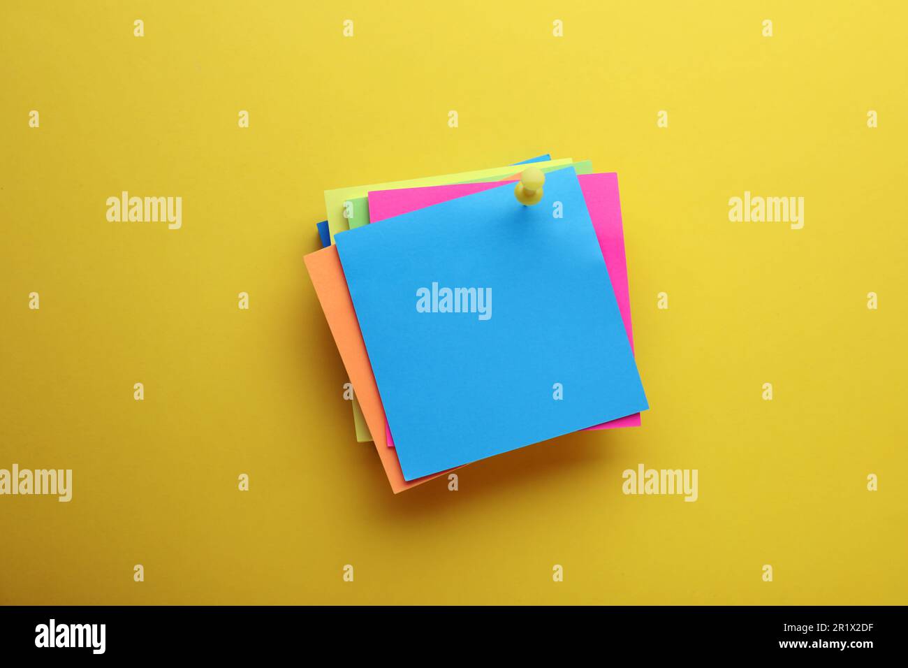 Paper notes on yellow background, top view Stock Photo - Alamy