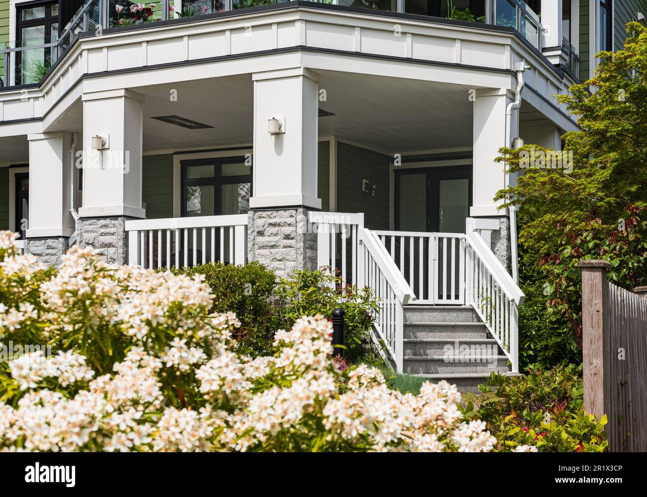 Entrance to a home through a beautiful garden with colorful flowers ...