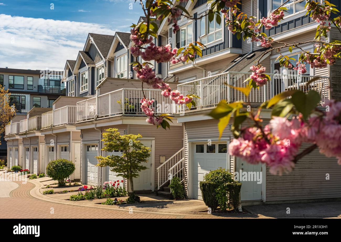 Facade of new residential townhouses. Modern buildings with garages in ...