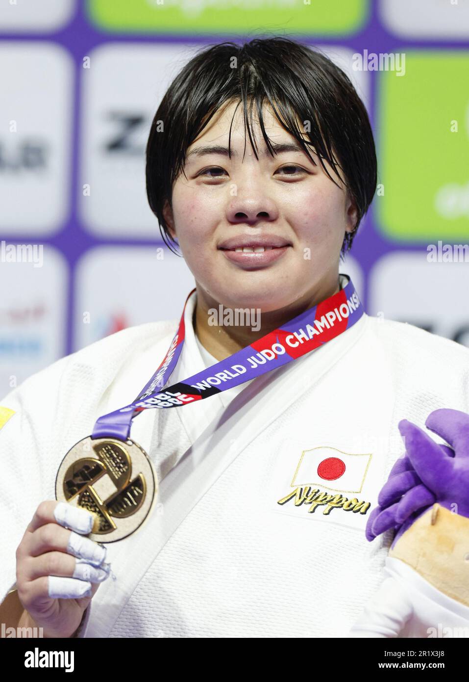 Japan's Akira Sone poses with the gold medal after winning the women's over-78-kilogram division ...