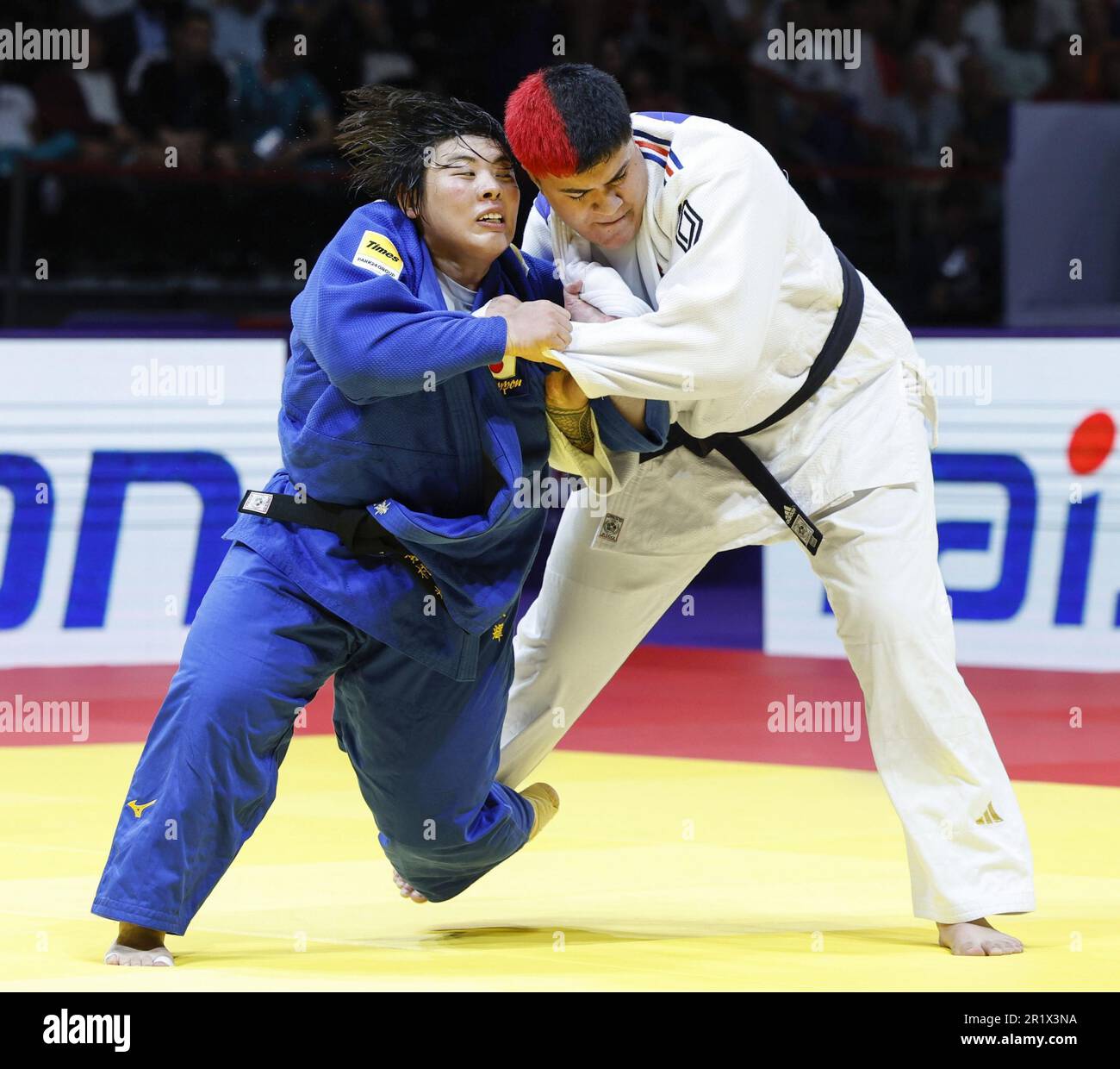Japan's Akira Sone (blue) takes on Julia Tolofua of France in the women's over-78-kilogram final ...
