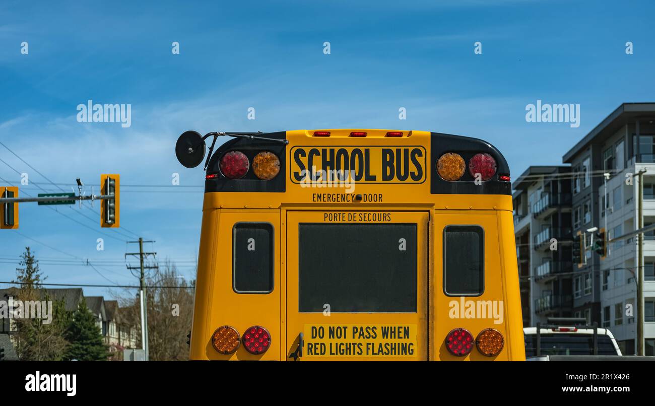School Bus on urban street road in the morning. School bus driving ...