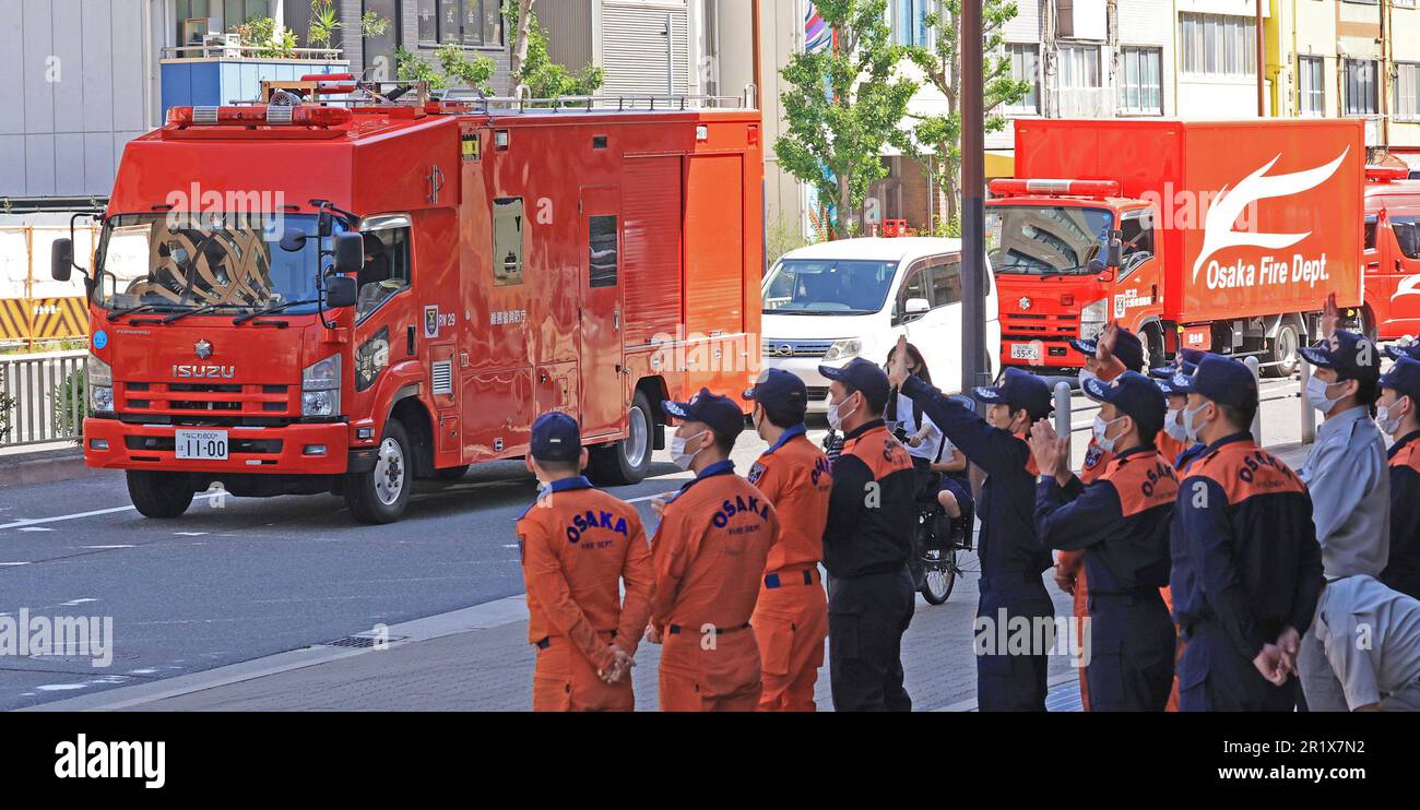Vehicles leave the Fire Defence headquarters of Osaka heading Hiroshima ...
