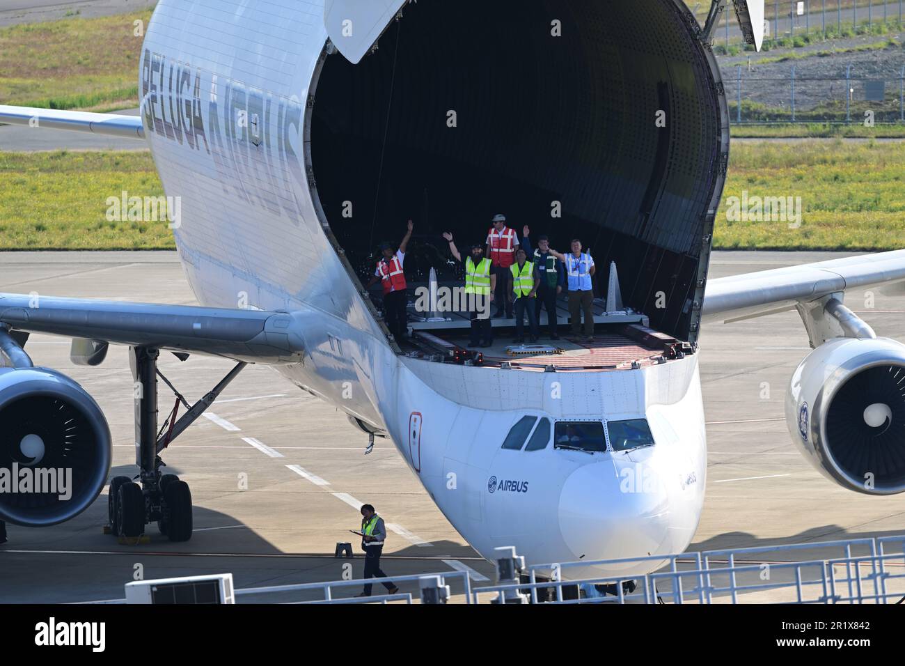 Staff members wave to people gathered on the observation deck from the ...