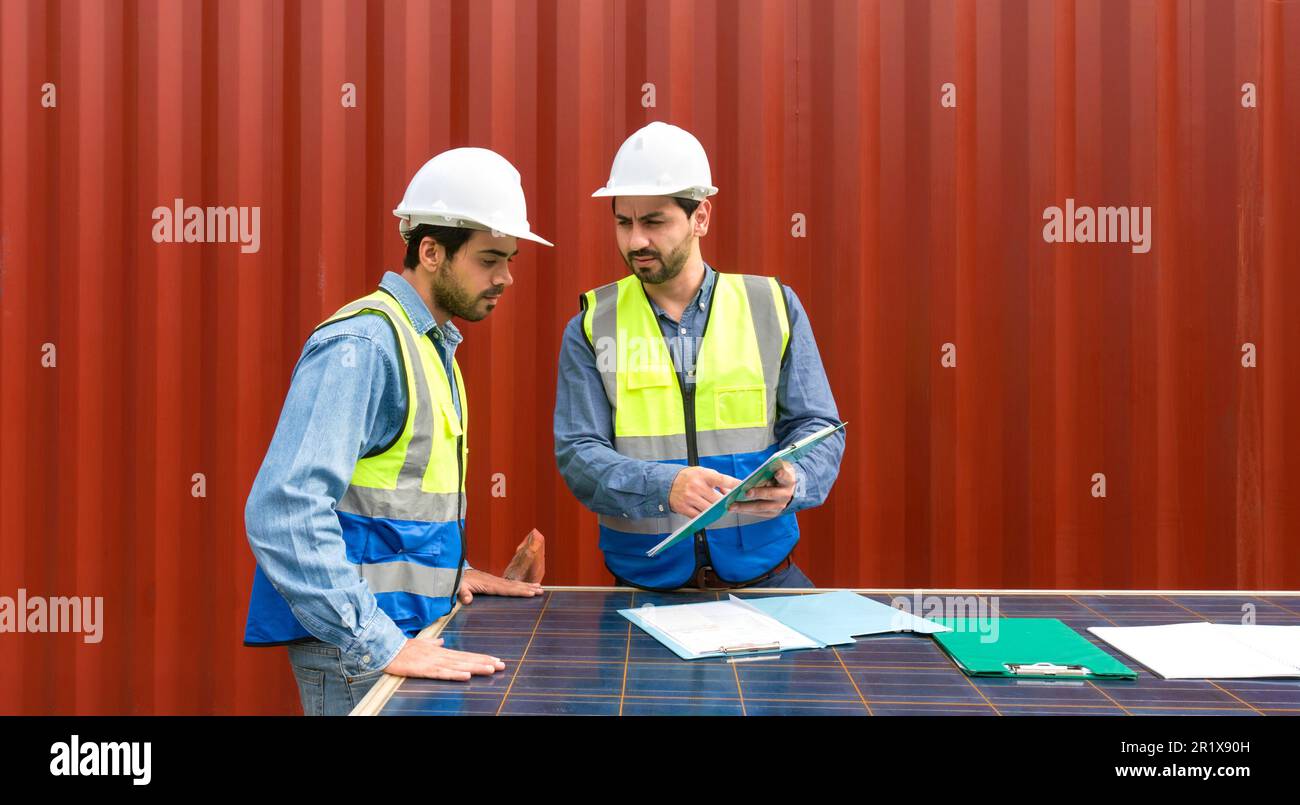 Shipment worker pointing at shipping schedule on clipboard, explain to ...