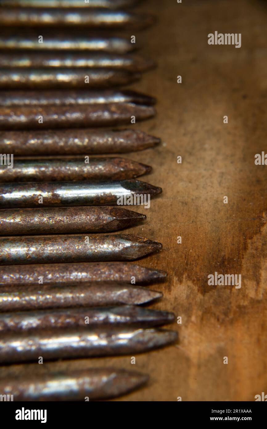 old rusty, 16 penny nails, line of sharp heavy penny nail points for ...