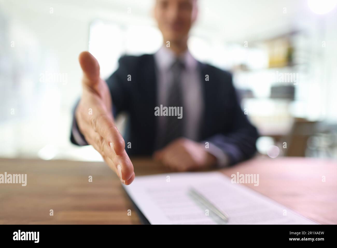 Successful businessman stretches out hand to do handshake Stock Photo ...