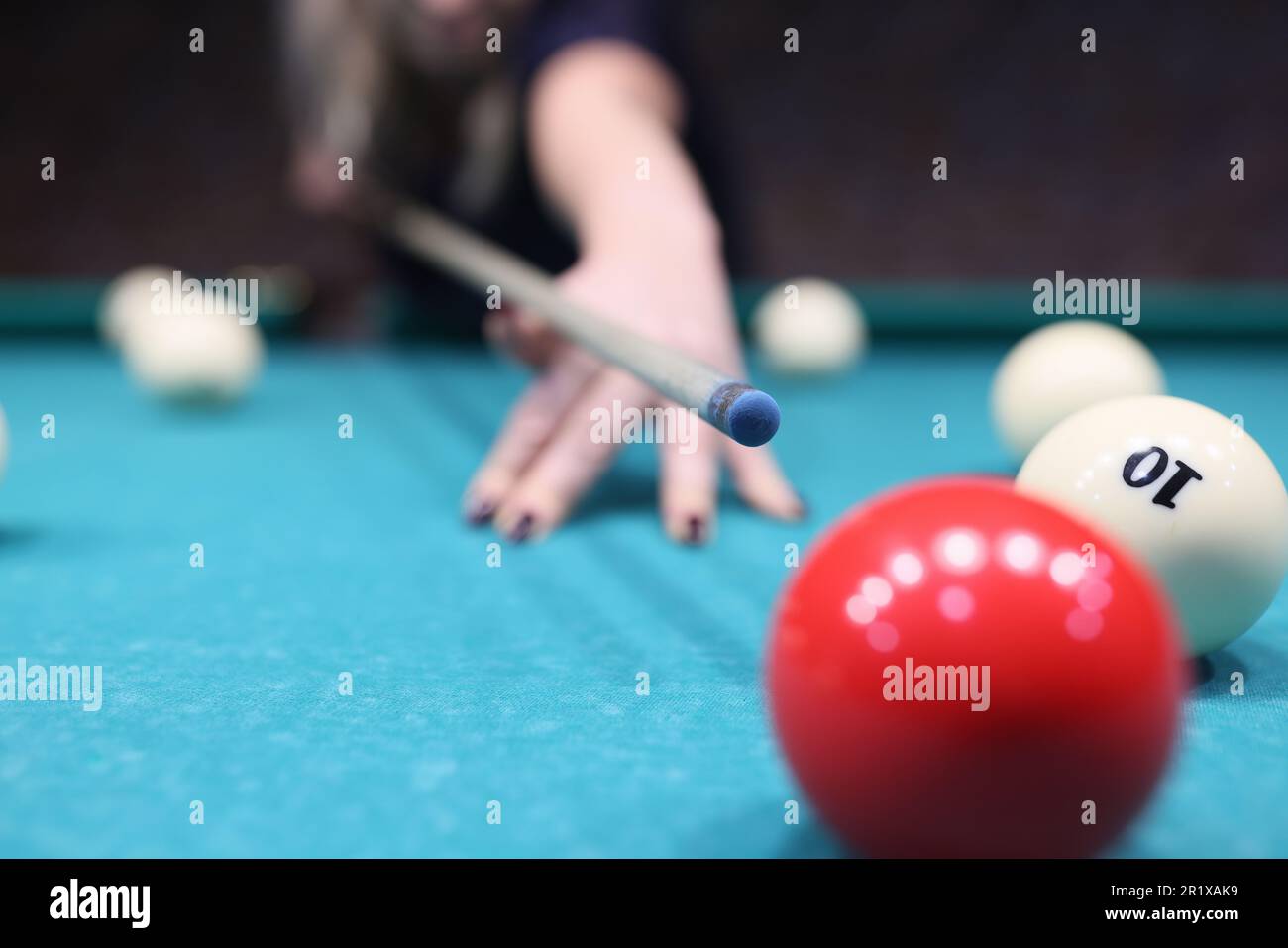 Venturous woman ready to hit red ball on blue pool table Stock Photo ...