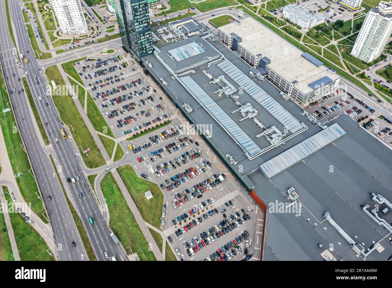 aerial view of shopping mall with crowded parking lot and highway ...