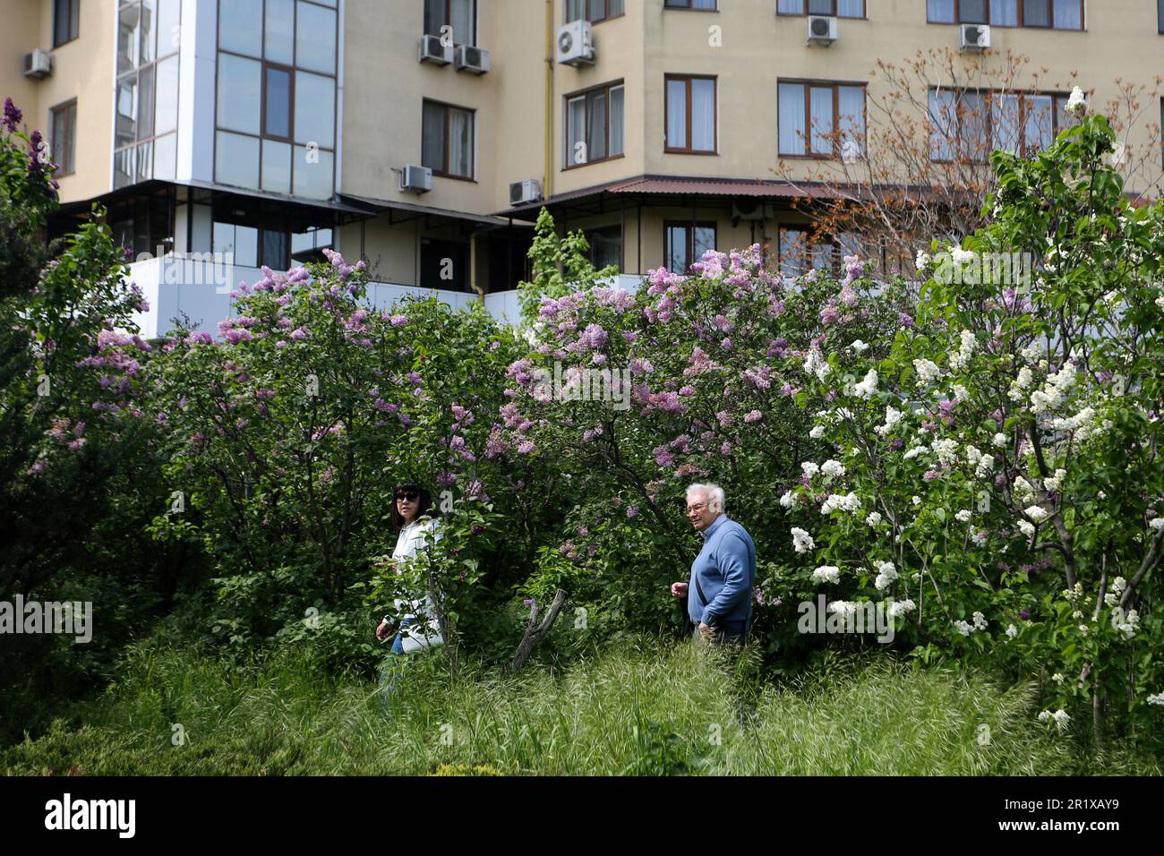 An elderly couple walks among flowering plants at the Odessa Botanical ...