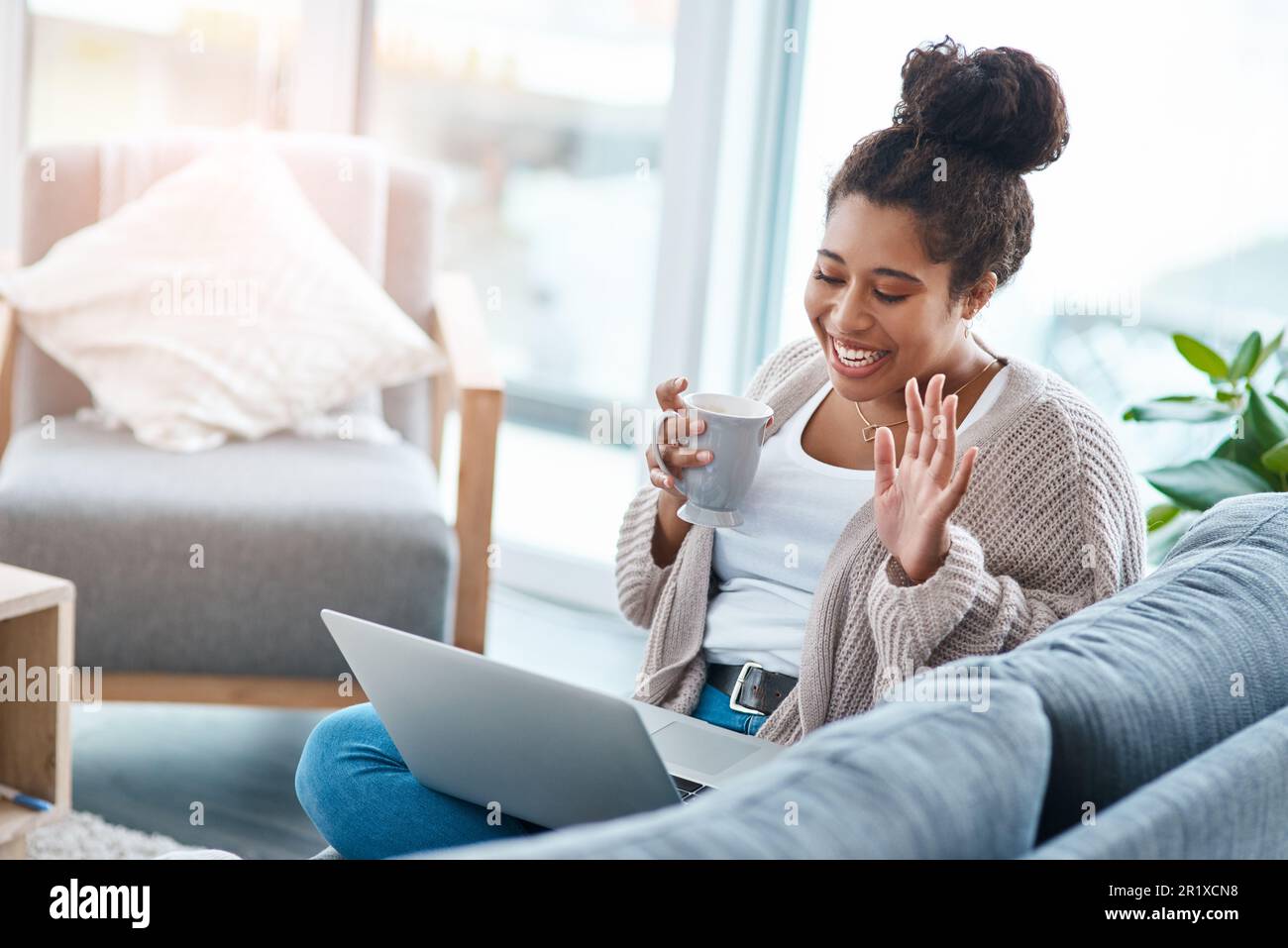 Happy woman, laptop and video call on home sofa with a smile and hand ...